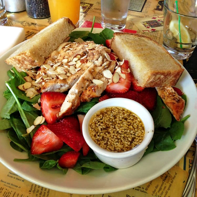 A salad that makes eating greens feel like cheating—strawberries, almonds, and chicken conspiring to make you forget you're being virtuous.