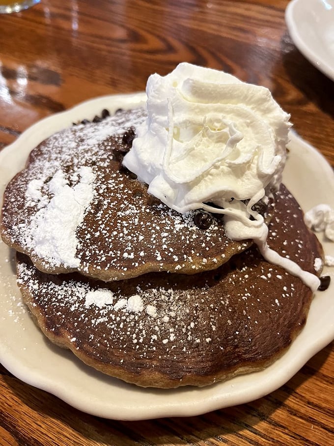 These chocolate pancakes with powdered sugar and whipped cream aren't just breakfast &ndash; they're the reason alarm clocks were invented.