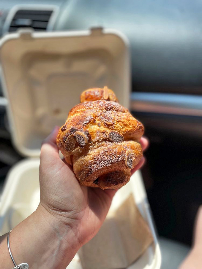 This chocolate almond croissant, enjoyed car-side, proves some of life's greatest pleasures are meant to be eaten while sitting in parking lots. 