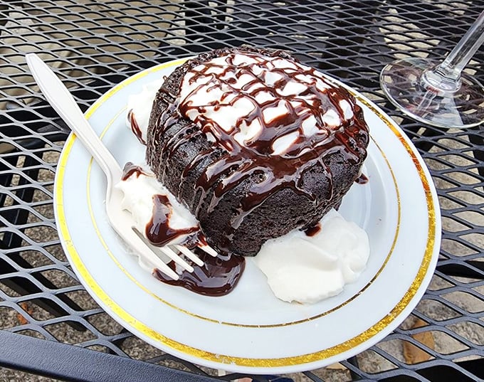 A chocolate bomb that detonates pure joy with each forkful. The whipped cream isn't garnish—it's the perfect cooling counterpoint to rich decadence.