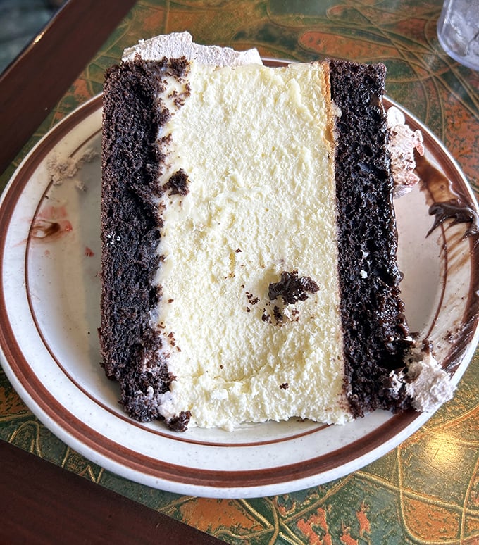 This isn't just chocolate cake&mdash;it's a layer cake masterpiece with what appears to be cream filling that demands to be savored one deliberate bite at a time.