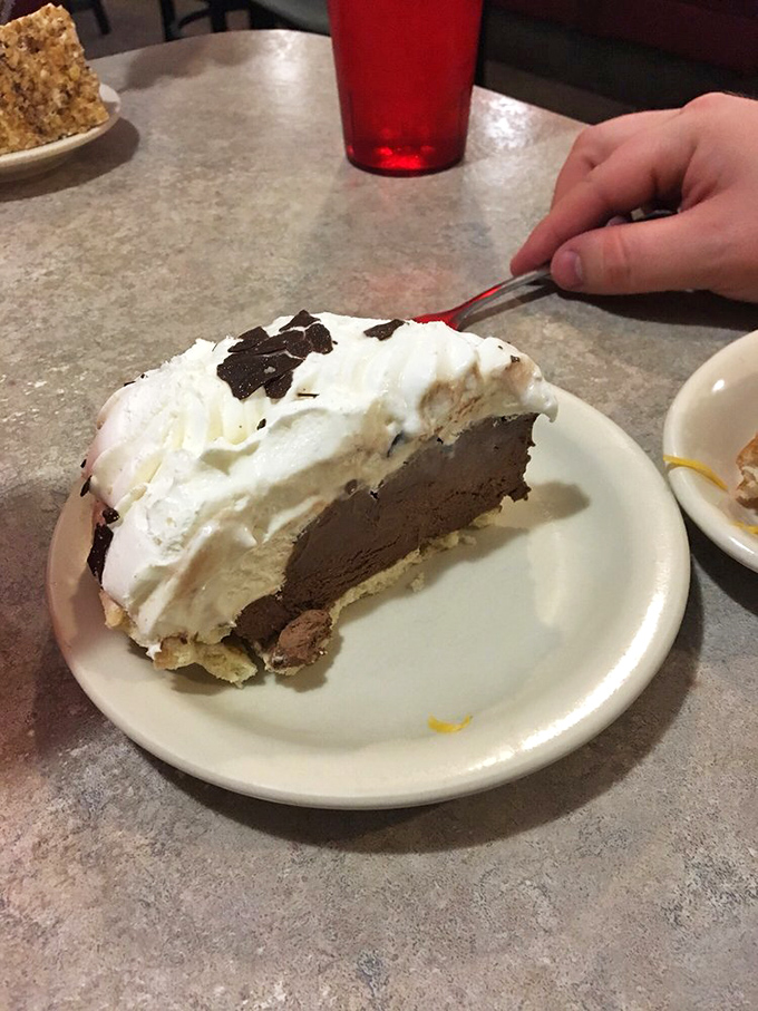 This chocolate cream pie isn't just dessert; it's the grand finale to a symphony of comfort food. That whipped cream crown deserves a standing ovation.
