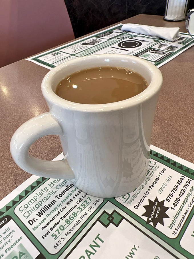 This isn't just coffee&mdash;it's liquid motivation in a sturdy white mug, ready to transform morning grumbles into actual human conversation.