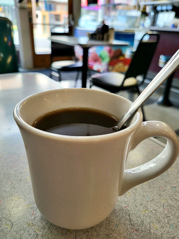 The humble diner coffee mug—holding the elixir that transforms grumpy humans into functioning members of society since forever.