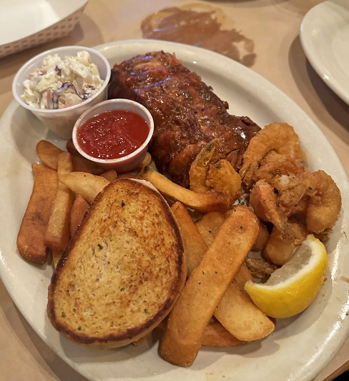 When you can't decide between land and sea, this plate delivers the best of both worlds with ribs, fries, and seafood.