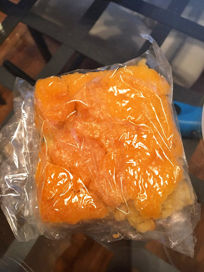 Cornbread wrapped like a precious gift, its golden-orange hue promising the perfect sweet-savory companion to cut through rich barbecue.