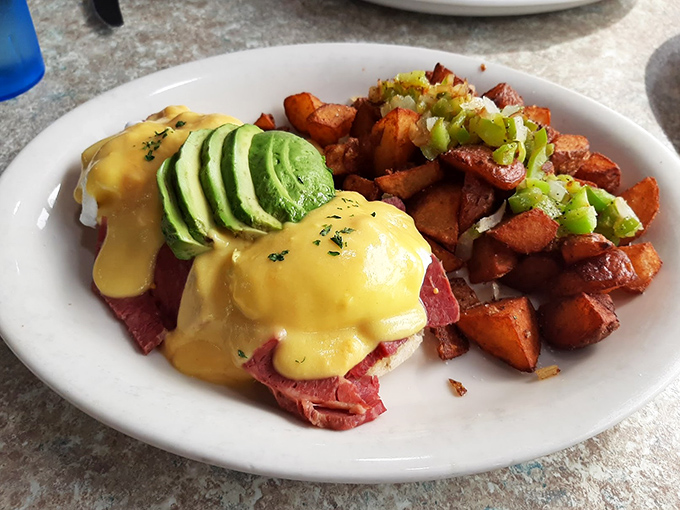 Eggs Benedict gets the corned beef treatment, topped with avocado slices that make this breakfast feel like California's delicious handshake.
