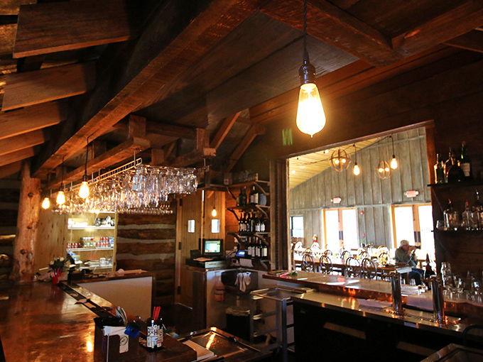 A bar that makes you want to cancel all other plans. Rustic beams, pendant lighting, and the promise of craft cocktails to complement your wild game feast.