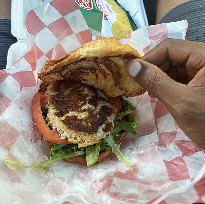This crab cake sandwich isn't just a meal—it's edible architecture with layers of flavor that would make Frank Lloyd Wright jealous.