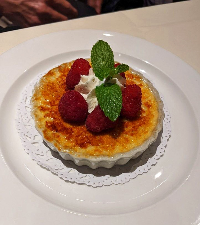 Cr&egrave;me br&ucirc;l&eacute;e with fresh raspberries&mdash;that perfect crack of caramelized sugar is the percussion section of the dessert symphony.