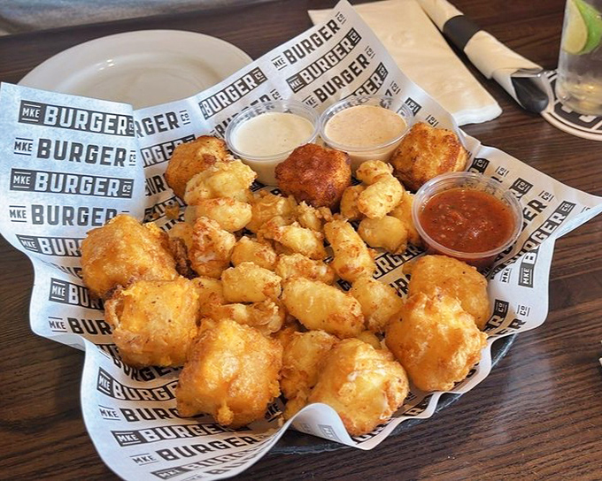 A cheese curd sampler that's basically a flight of happiness served on one glorious plate.
