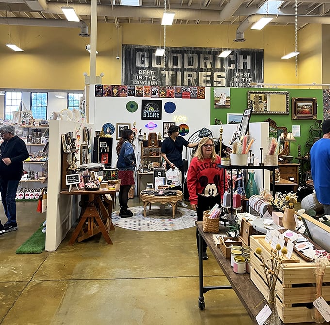 Beneath the vintage Goodrich Tires sign, shoppers engage in the timeless dance of discovery. That Mickey Mouse sweatshirt is someone's childhood memory waiting to be adopted.