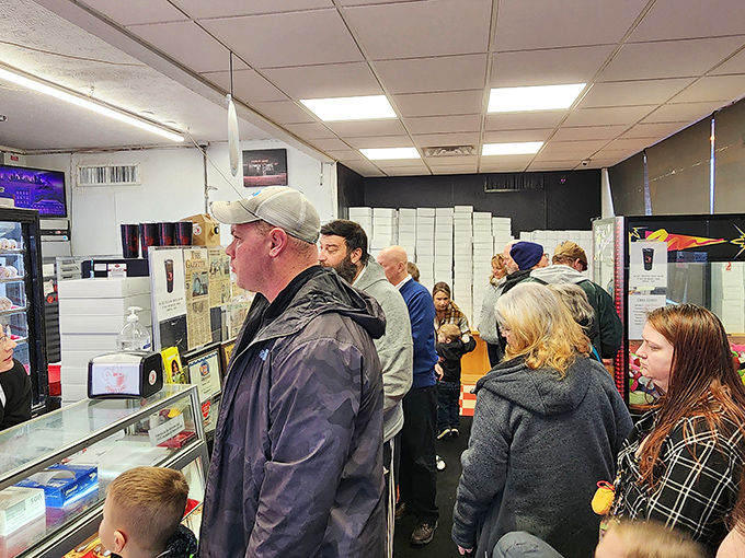 The morning rush at Donut Land &ndash; where strangers become friends united by the universal language of fried dough appreciation.