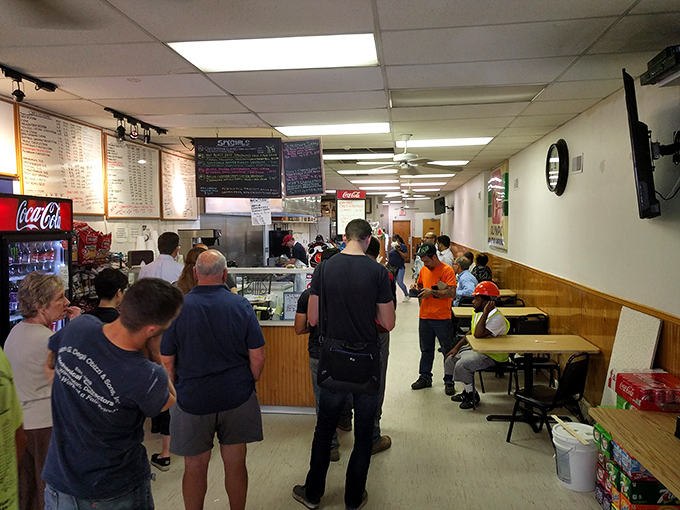 The lunch line of anticipation&mdash;where strangers become comrades united by the universal language of impending sandwich satisfaction.