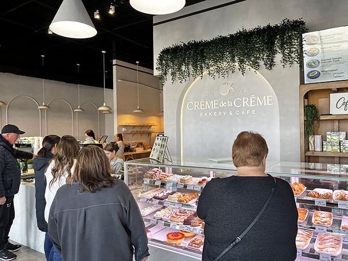 The display case draws customers like moths to a flame. Behind that glass lies a universe of butter, sugar, and flour transformed into magic.
