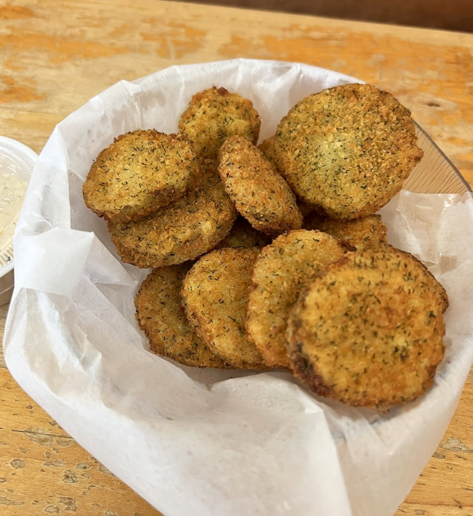 These aren't just fried pickles&mdash;they're crunchy little discs of tangy perfection that disappear faster than your willpower.