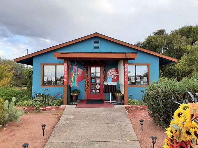 The vibrant blue Desert Dancer building stands out like a tropical oasis in the desert, complete with sunflowers that seem to be applauding your arrival.