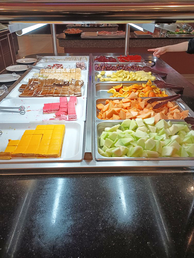 The dessert section proves that happiness comes in squares of many colors. Those fruit trays are just there to help you pretend you're making healthy choices.