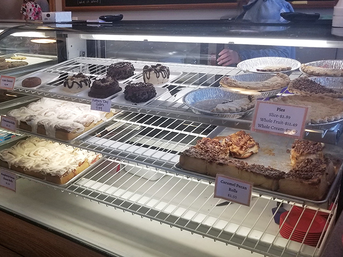 Sweet temptation behind glass. The display case serves as a museum of edible art, with each shelf offering a different path to happiness.