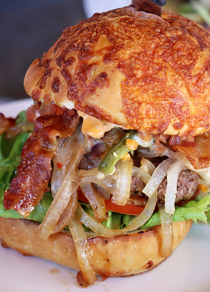 This isn't just a burger; it's architecture. The Devil Revenge stacks bacon, cheese, and caramelized onions into a tower of flavor that requires jaw gymnastics.