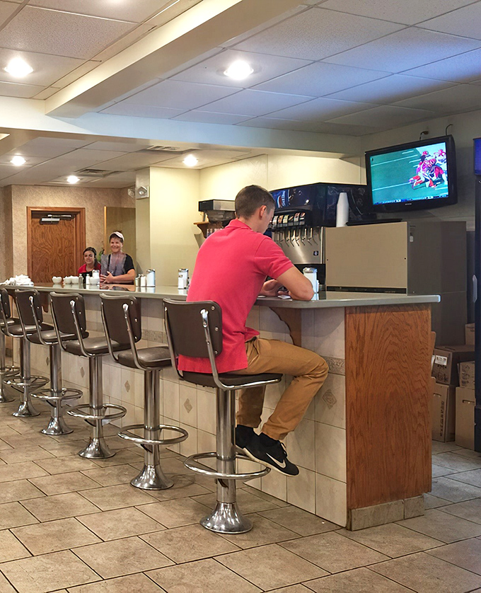 The counter seating—where solo diners become temporary neighbors and the day's news travels faster than the specials.