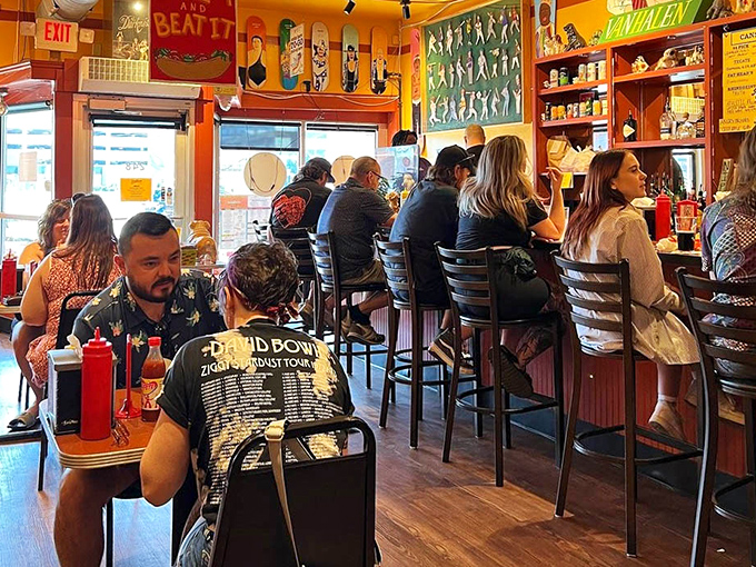 Locals crowd the bar, united in the universal language of hot dog appreciation&mdash;a community built on shared love for creative comfort food.