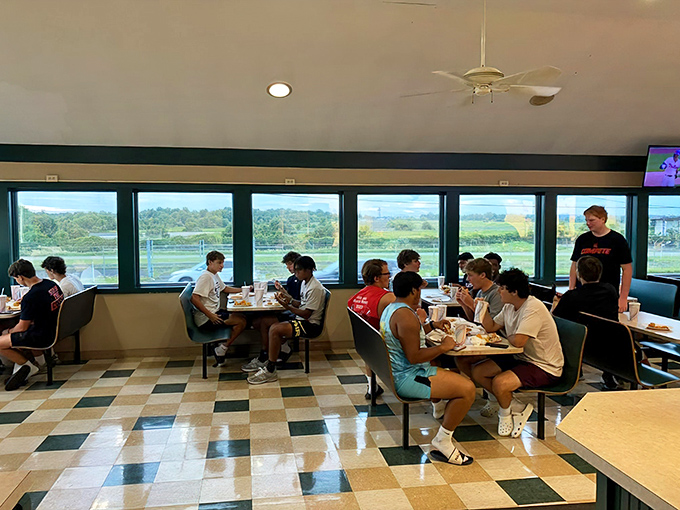 Where sandwich enthusiasts of all ages gather like pilgrims at a culinary shrine. Notice the focused expressions of pure enjoyment.