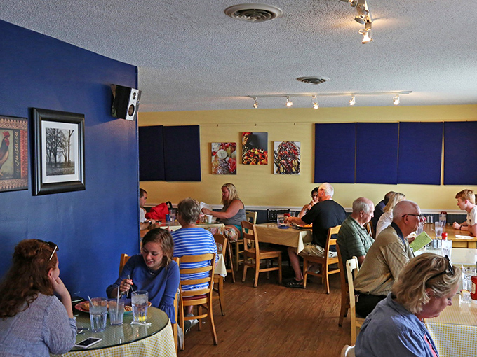 Blue and yellow walls frame a dining room where strangers become friends over shared syrup bottles and coffee refills.