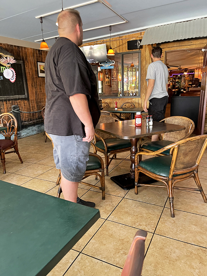 Patrons navigate the dining room like seasoned Florida explorers. The wooden paneling has absorbed decades of satisfied "mmms" and "ahhhs."