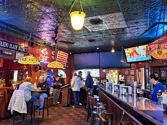 Where locals and tourists mingle at the bar, sharing stories over Hungarian hot dogs and cold beers beneath the distinctive pressed-tin ceiling.