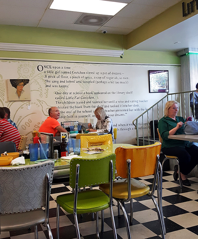 The story of Gretchen unfolds on the wall while diners create their own stories at tables below. Notice the colorful chairs—yellow isn't just a color, it's a mood.