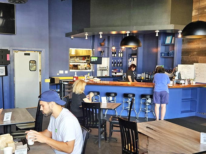The blue counter creates a stage where burger magic happens. Like watching artisans at work, the staff orchestrates your meal with practiced precision.