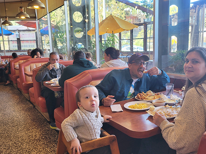 Multi-generational dining at its finest, where the baby's wide-eyed wonder matches the adults' anticipation of that first heavenly bite.