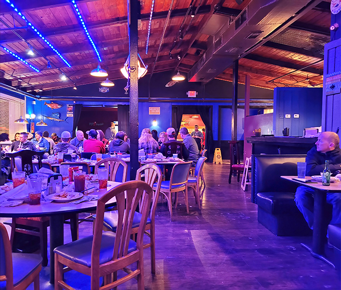 Blue lighting transforms dinner into an underwater adventure. These diners aren't just eating&mdash;they're participating in an oceanic ritual hundreds of miles inland.