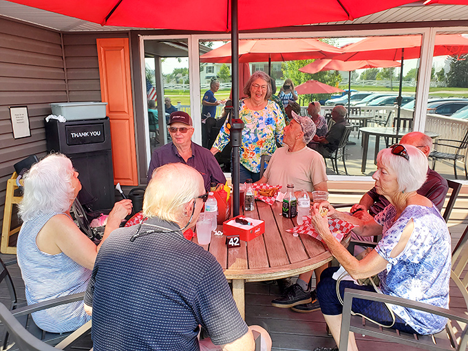 The patio: where strangers become friends united by the universal language of exceptional hot dogs and summer sunshine.