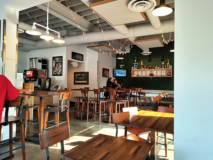 The dining area balances modern industrial elements with warmth, creating a space where the chicken remains the star but the setting deserves its own applause.