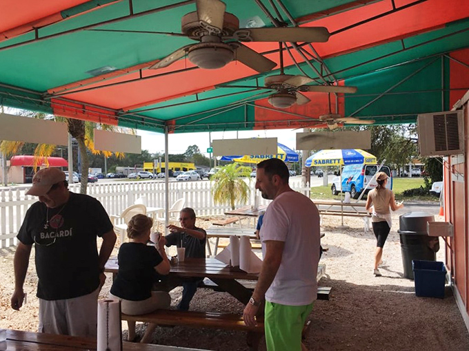 The covered patio brings together strangers united by one noble pursuit&mdash;the perfect hot dog experience on a sunny Florida day.