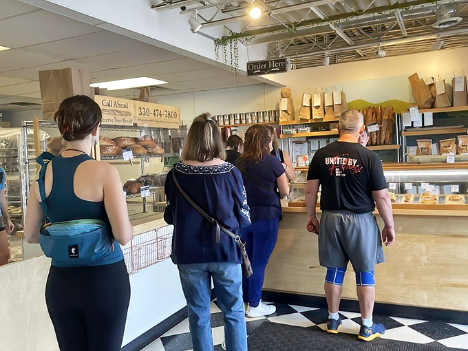 The universal bakery stance: customers contemplating which delicious decision will haunt their dreams tonight.