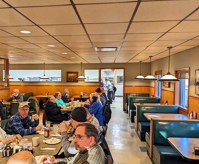 The breakfast crowd at Lyn-Way—where regulars have their own unassigned-assigned seats and the coffee refills arrive before you realize you need one.