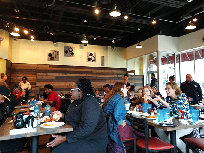 A bustling dining room where strangers become temporary breakfast companions, united by the universal language of "pass the syrup, please."