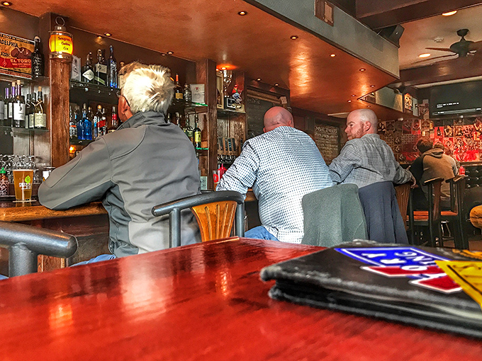 The bar becomes its own little community where conversations flow as freely as the craft beverages.