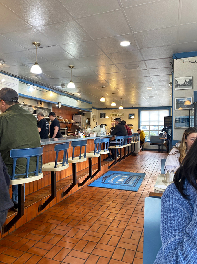 The counter ballet &ndash; regulars perched on blue stools watching the morning's choreography of spatulas and coffee pots with appreciative eyes.