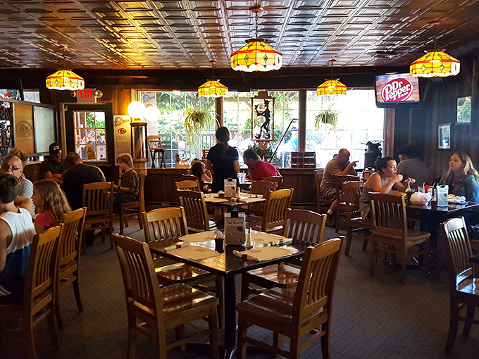 Tiffany-style lamps cast a warm glow over diners deep in that universal restaurant ritual&mdash;ignoring their companions while studying the menu.