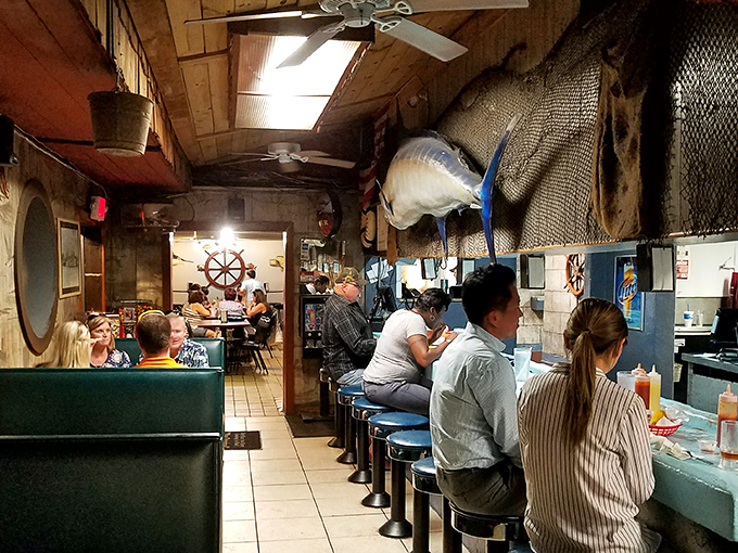 The oyster bar in full swing&mdash;where strangers become friends over shared condiments and seafood stories. Community building, one shell at a time.