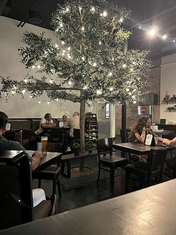That olive tree isn't just decoration&mdash;it's the heart of the restaurant, strung with lights like a year-round celebration of Mediterranean flavors.