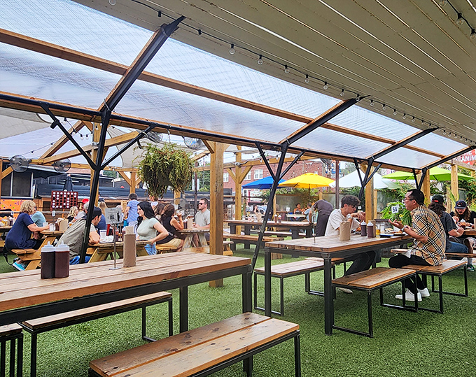 The covered outdoor dining area buzzes with the energy of happy eaters. Picnic tables, fresh air, and the collective joy of people united by great barbecue.