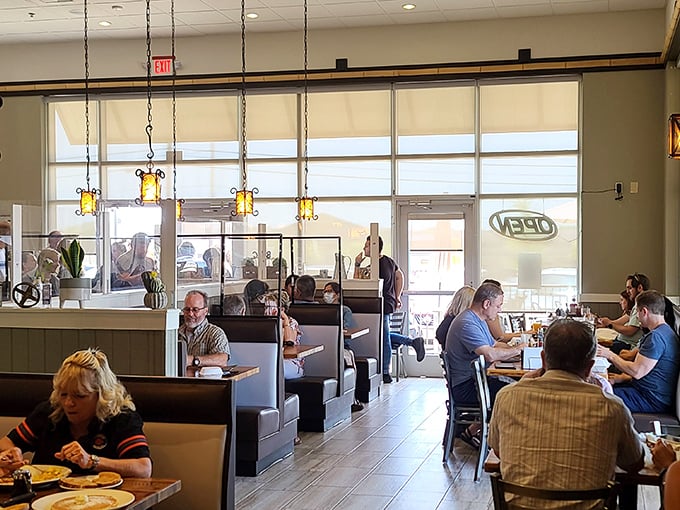 A bustling dining room where strangers become temporary neighbors, united by the universal language of "pass the syrup, please."