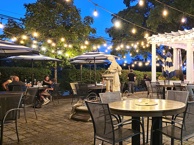 Dinner under the stars, Greek-style. String lights create a magical atmosphere that turns a simple meal into an event worth remembering.