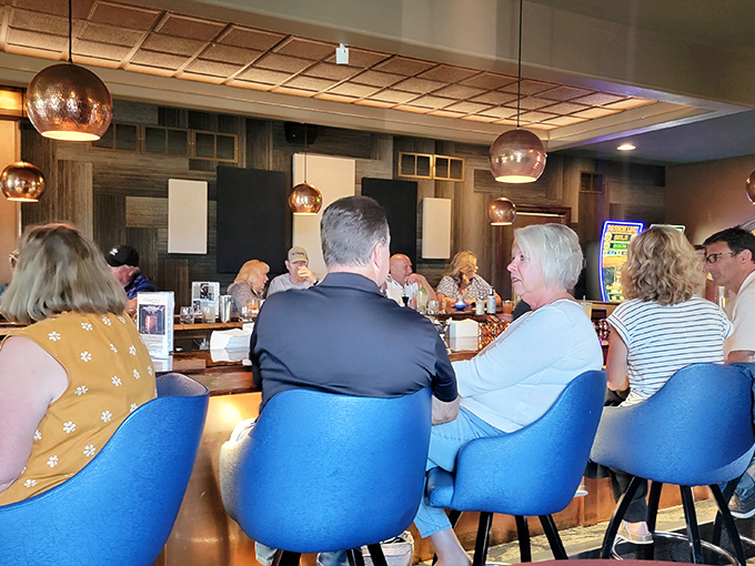 Conversations flow as freely as the cocktails at Cimaroli's bar. The blue chairs aren't just comfortable&mdash;they're front-row seats to community in action.