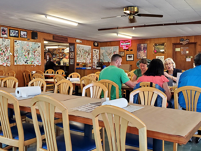 Locals and visitors alike gather at these tables, united by the universal language of "pass the Old Bay, please."